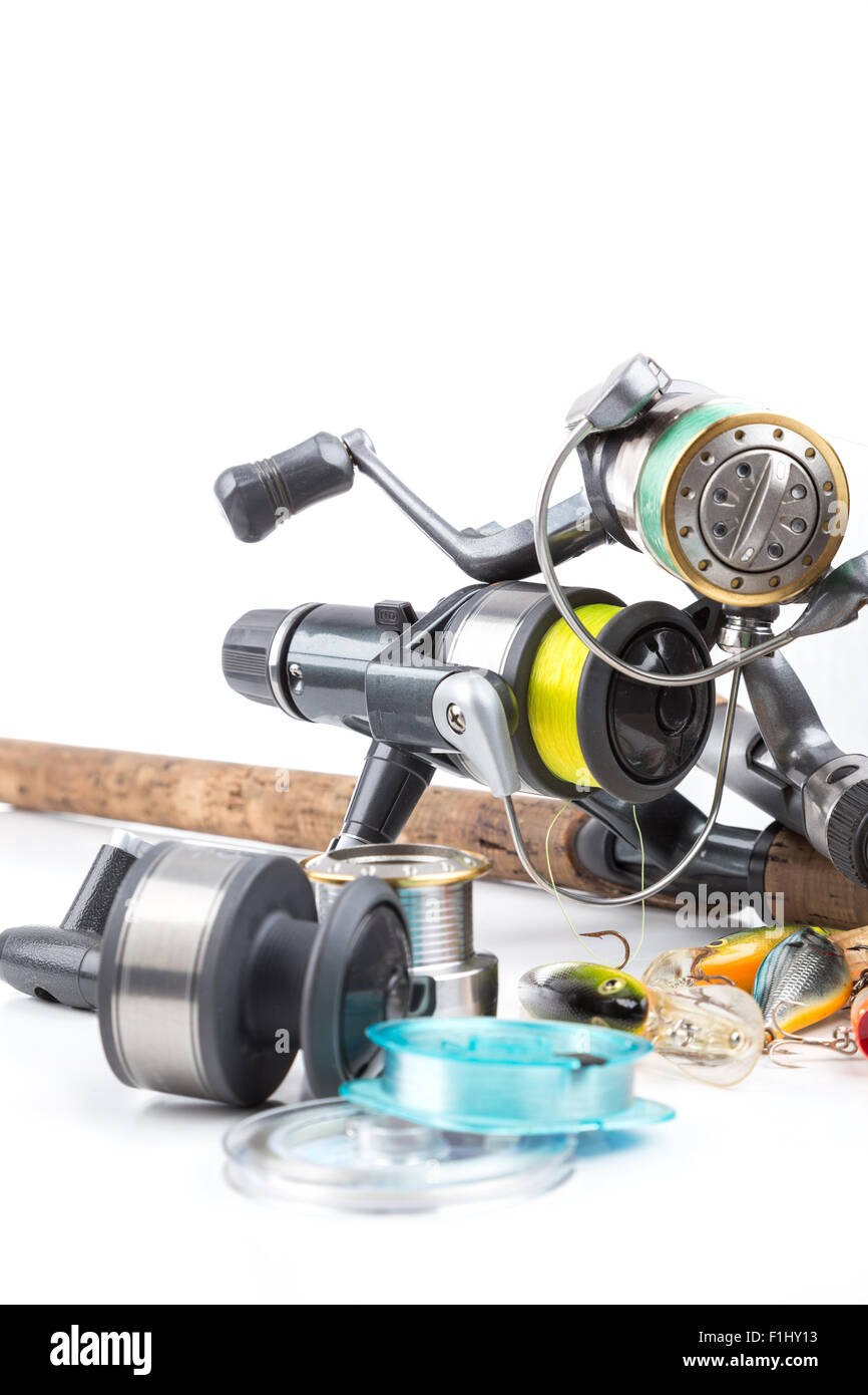 different fishing tackles - rod, reel, line and lures on white ...