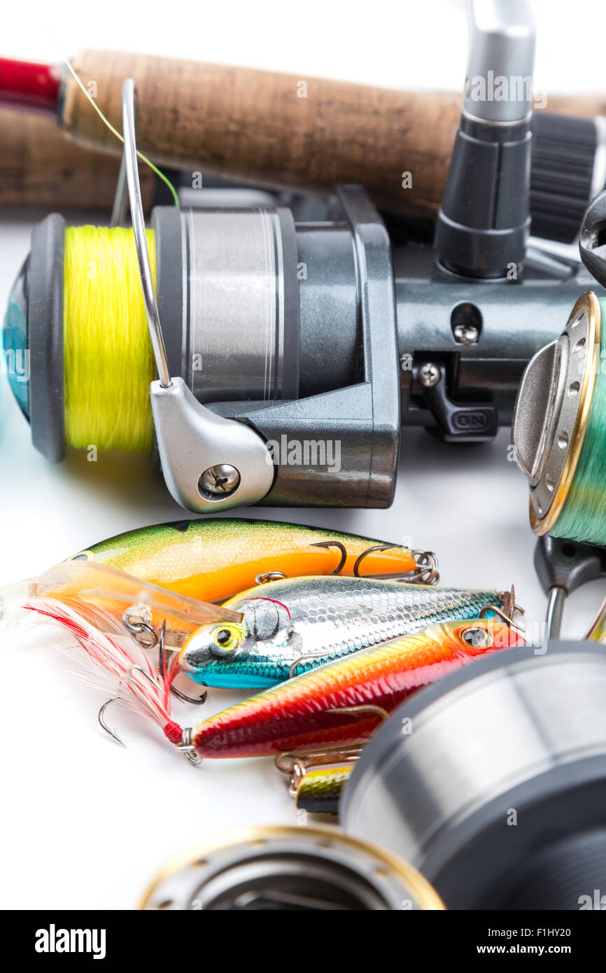 different fishing tackles - rod, reel, line and lures on white ...