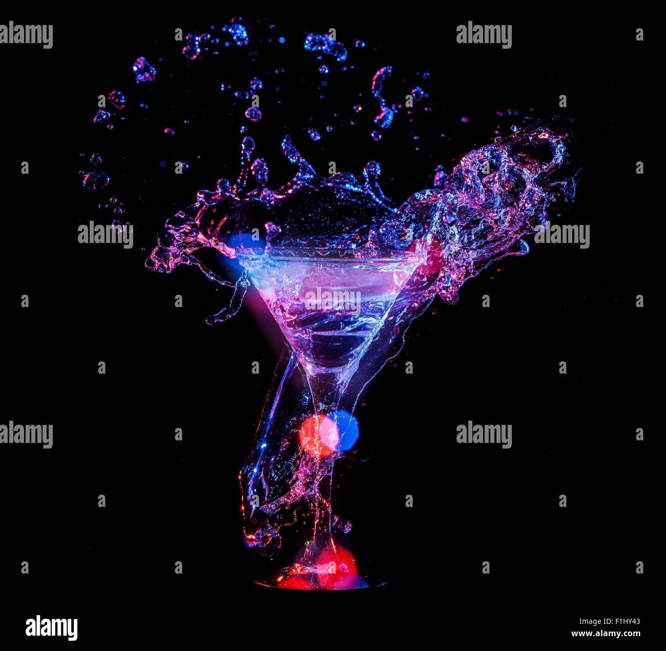 Bright cocktail with splashing water Stock Photo - Alamy