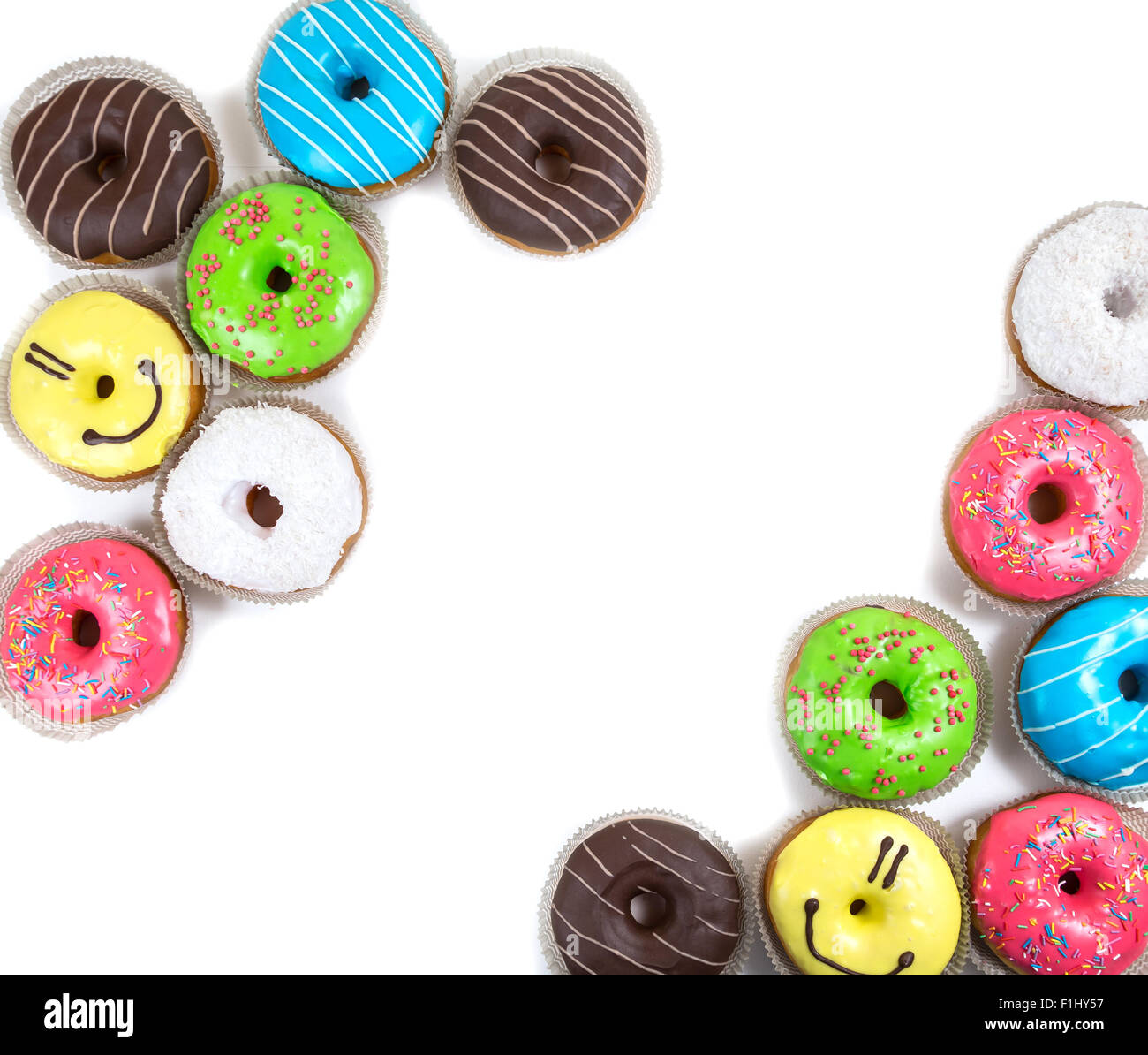 top frame from assorted glazed doughnuts in different colors on white ...