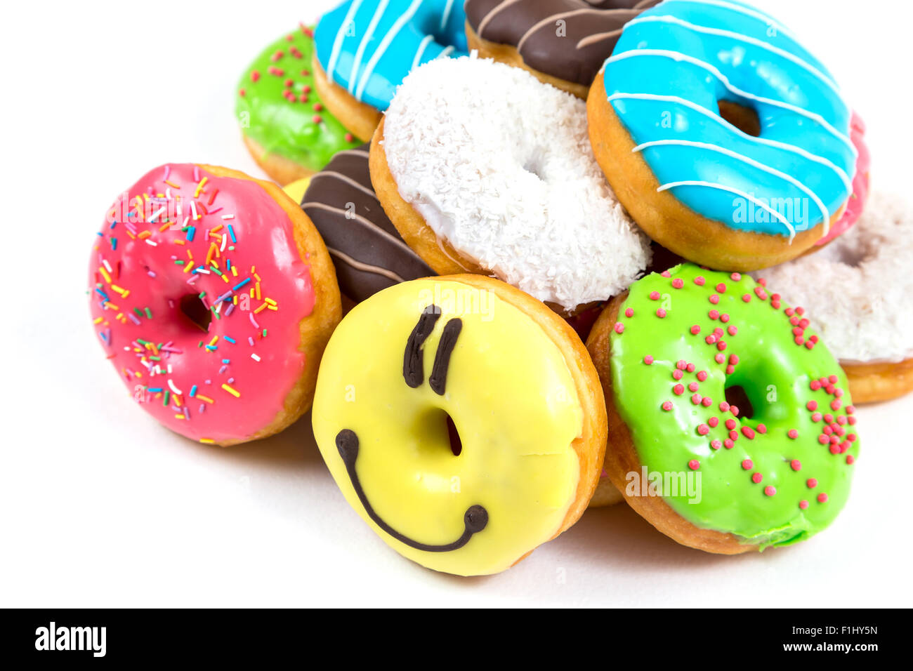 assorted glazed doughnuts in different colors on white background Stock ...