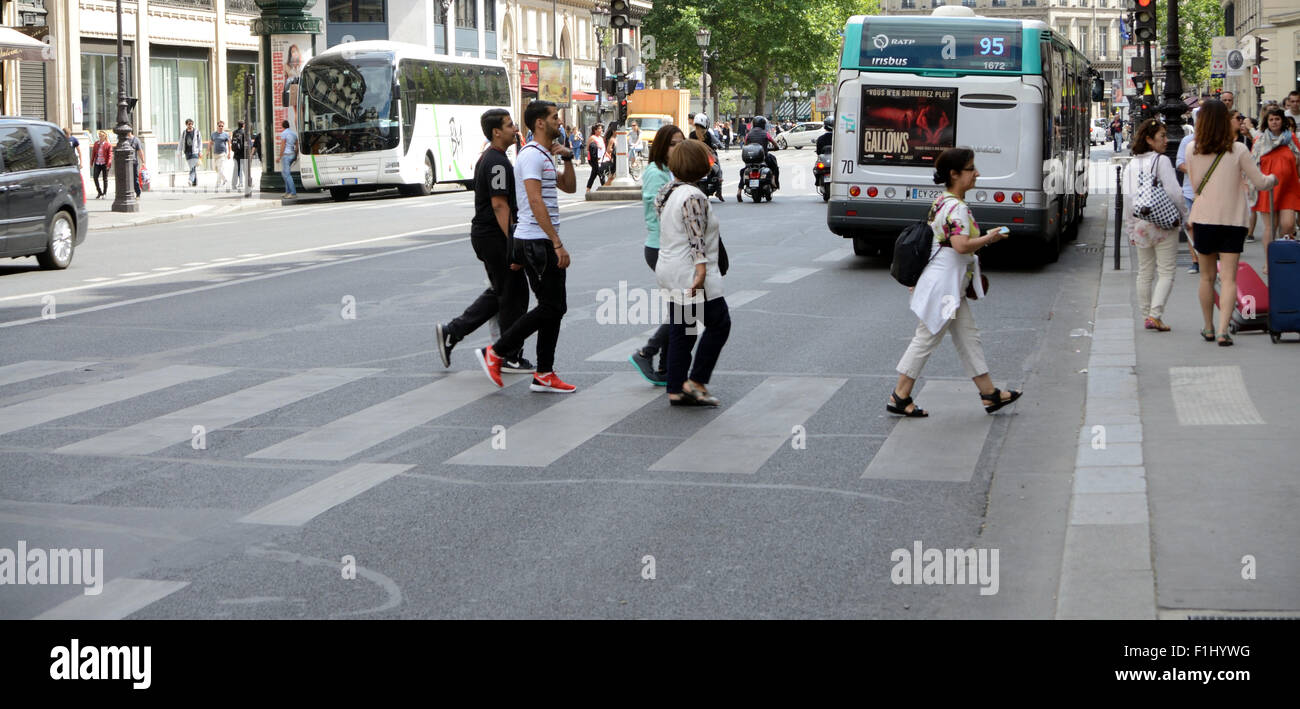 People cross a street in Paris using a pedestrian crossing Stock Photo ...