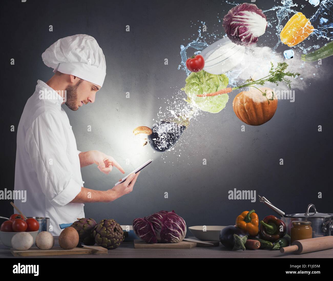 Cooking recipe from tablet Stock Photo - Alamy