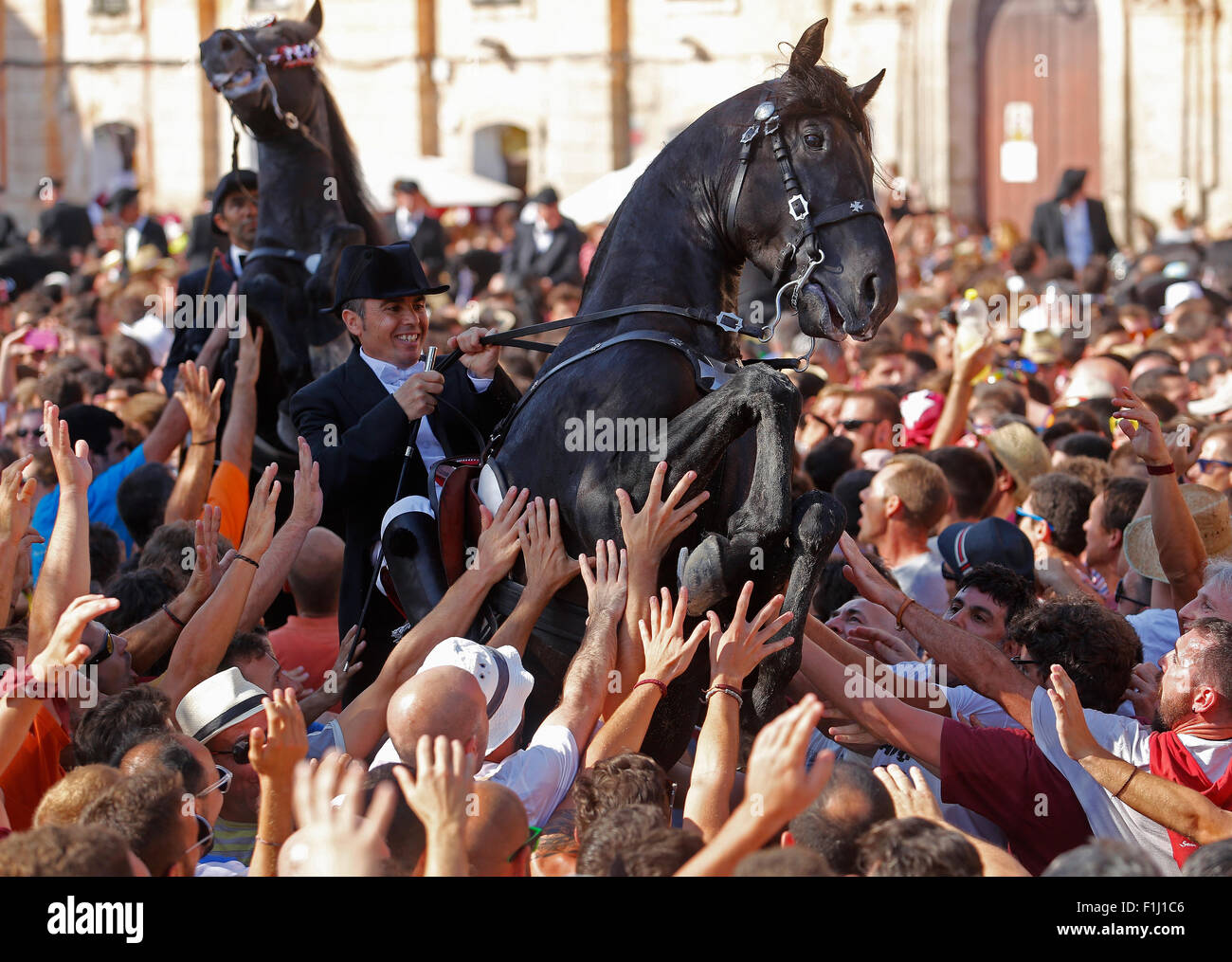A horse rears up surrounded by a cheering crowd during the Saint John ...