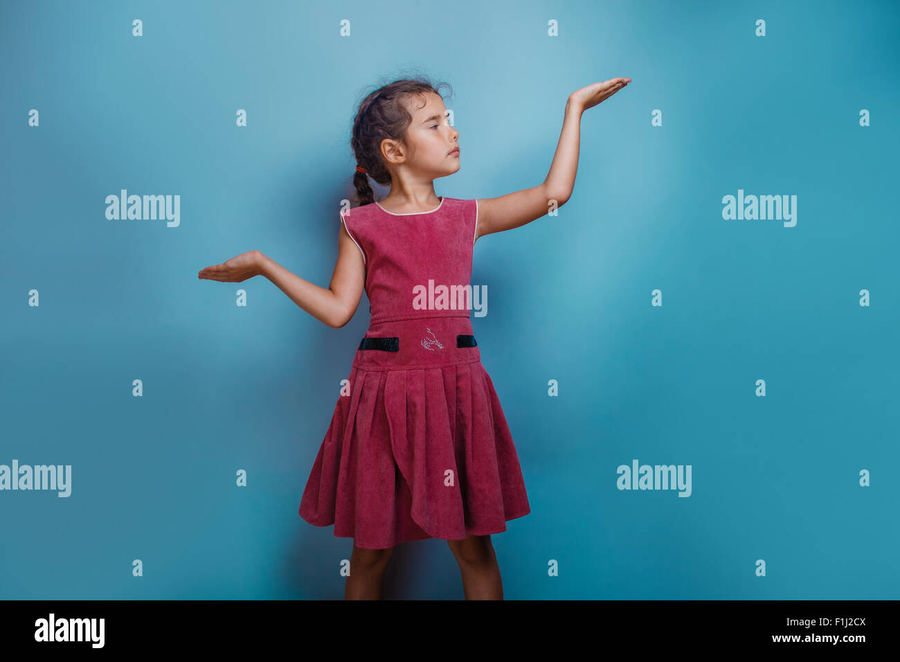 Girl European appearance ten years shows gesture scales hands on Stock ...