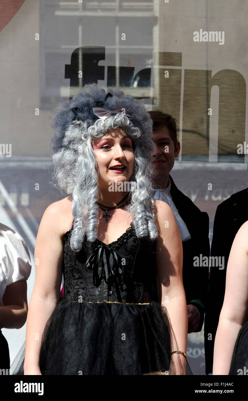 Female member of a theatre group performing a song from their show at ...
