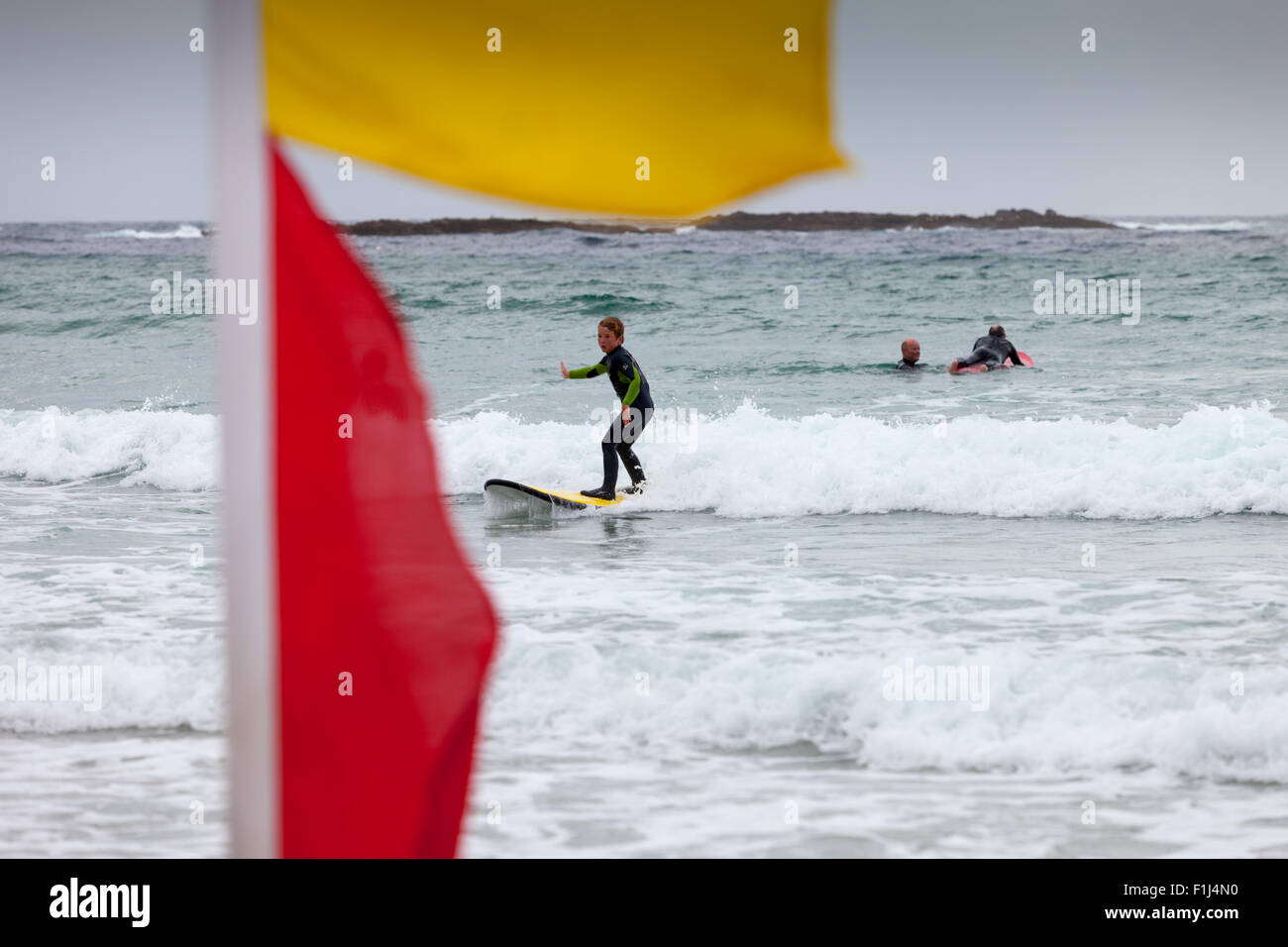 Red and yellow flag used on a beach in Cornwall to denote that the ...