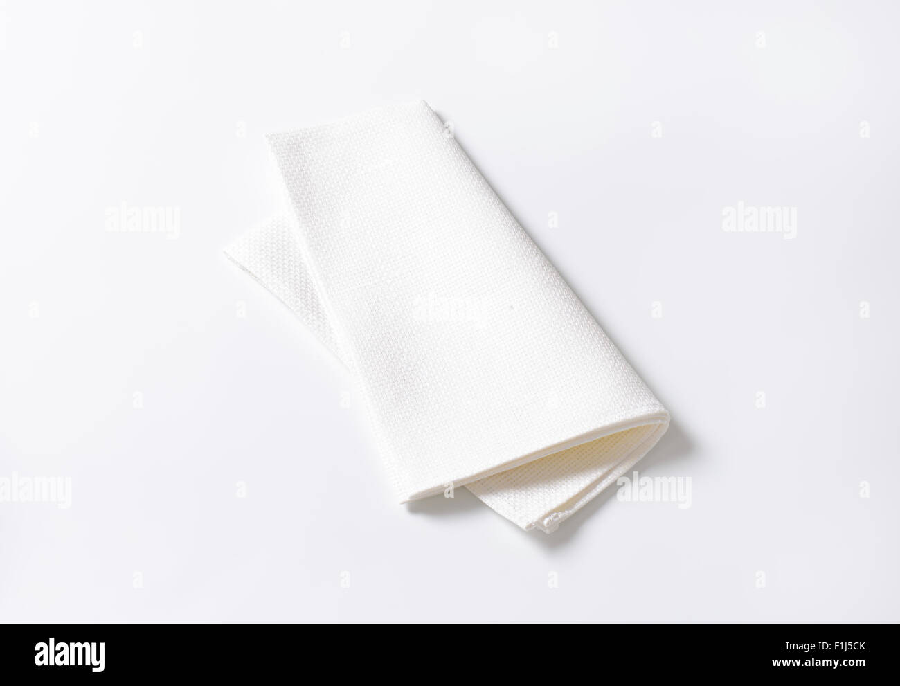 folded white napkin on white background Stock Photo - Alamy