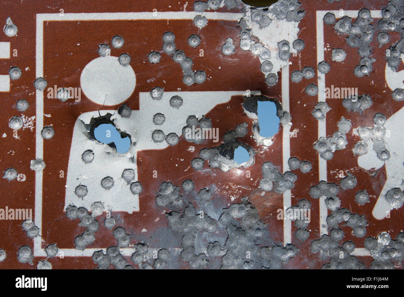 A recreation sign that shows hunting is allowed is shot full of bullet ...