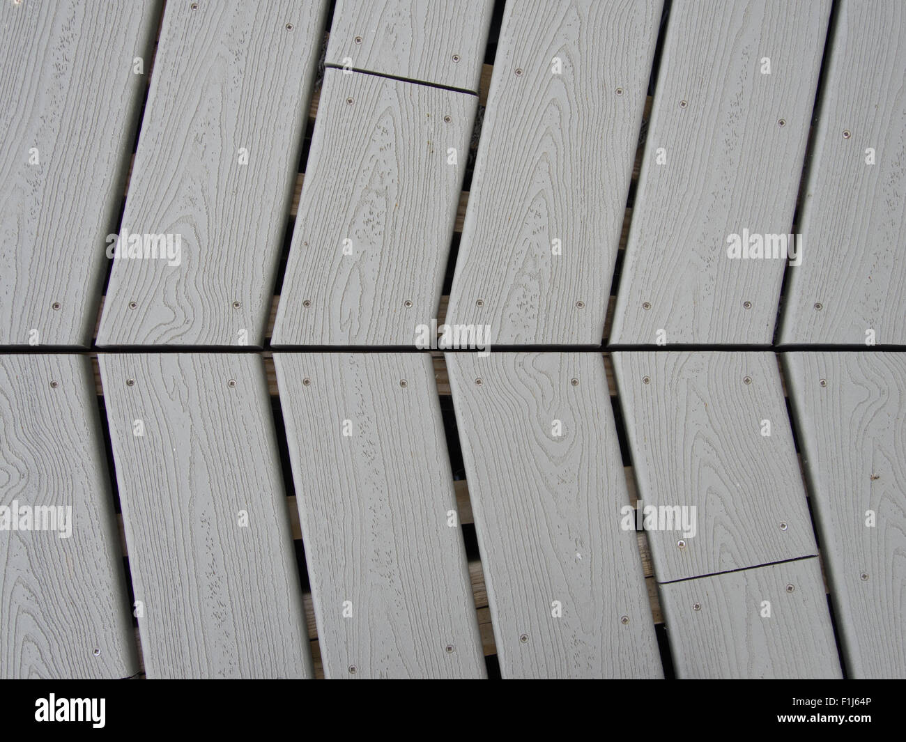 Plastic lumber decking produces interesting patterns on a river walkway ...
