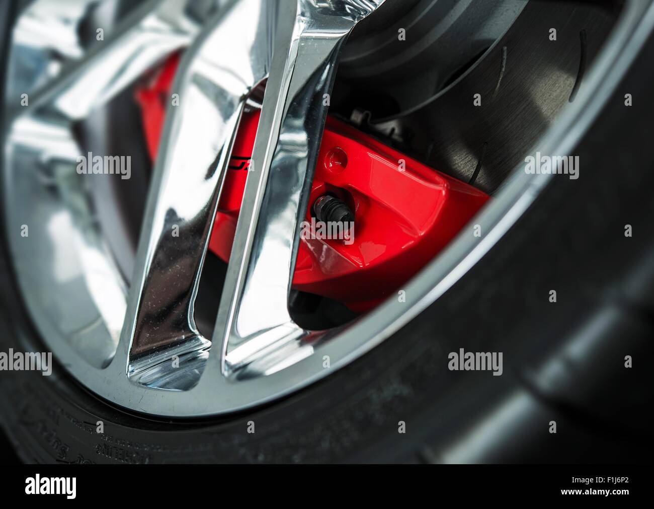 Red Car Brakes Closeup and Chromed Alloy Wheel. Low Profile Sport Tire Stock Photo - Alamy