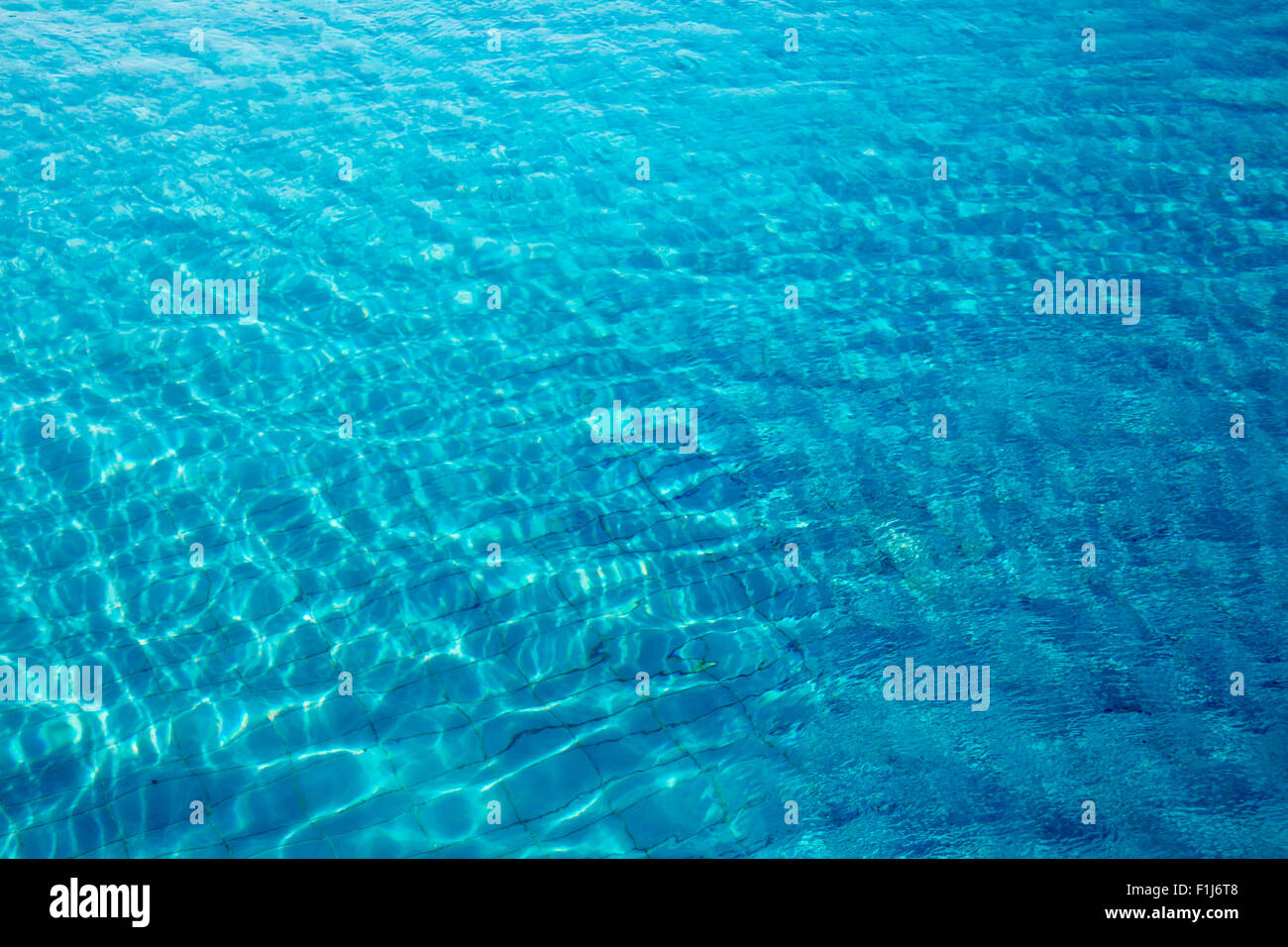 Hotel swimming pool with sunny reflections Stock Photo - Alamy