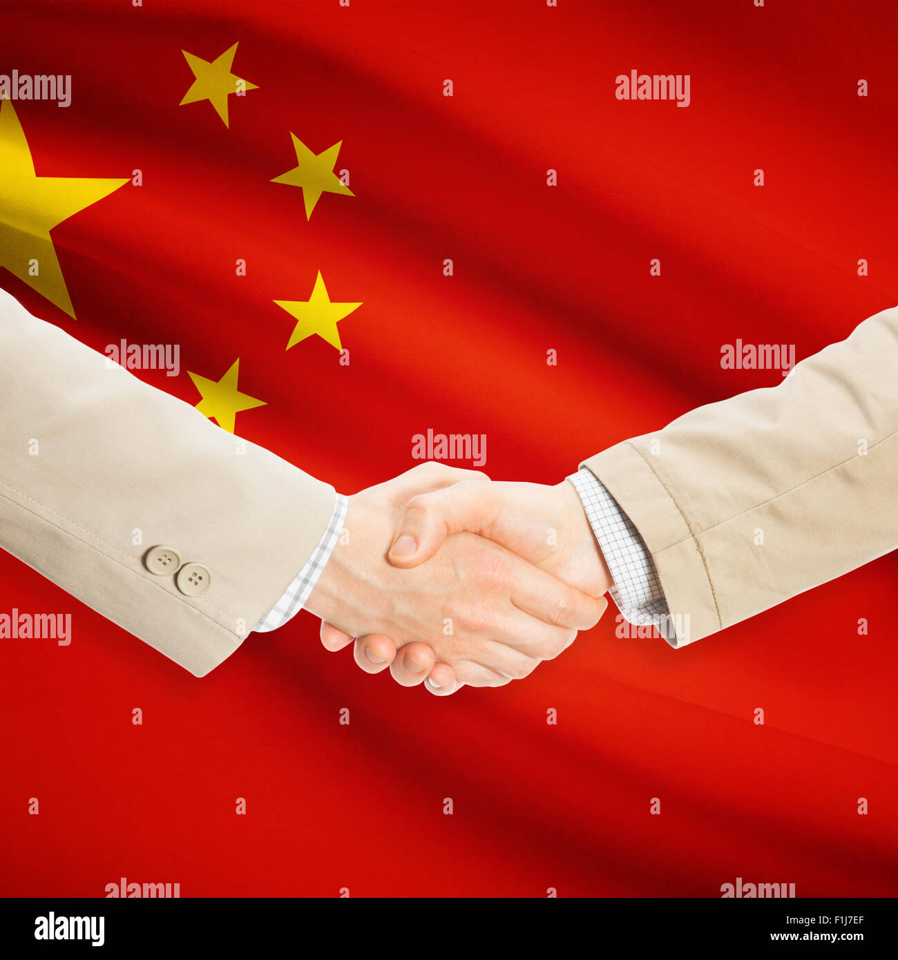 Businessmen shaking hands with flag on background - People's Republic ...