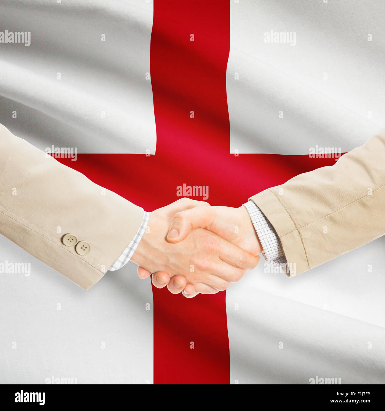 Businessmen shaking hands with flag on background - England Stock Photo ...