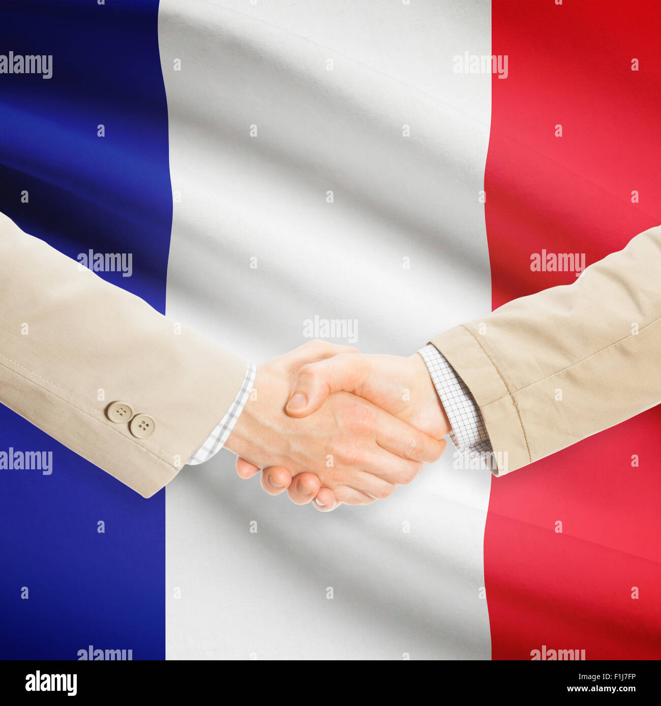 Businessmen shaking hands with flag on background - France Stock Photo ...