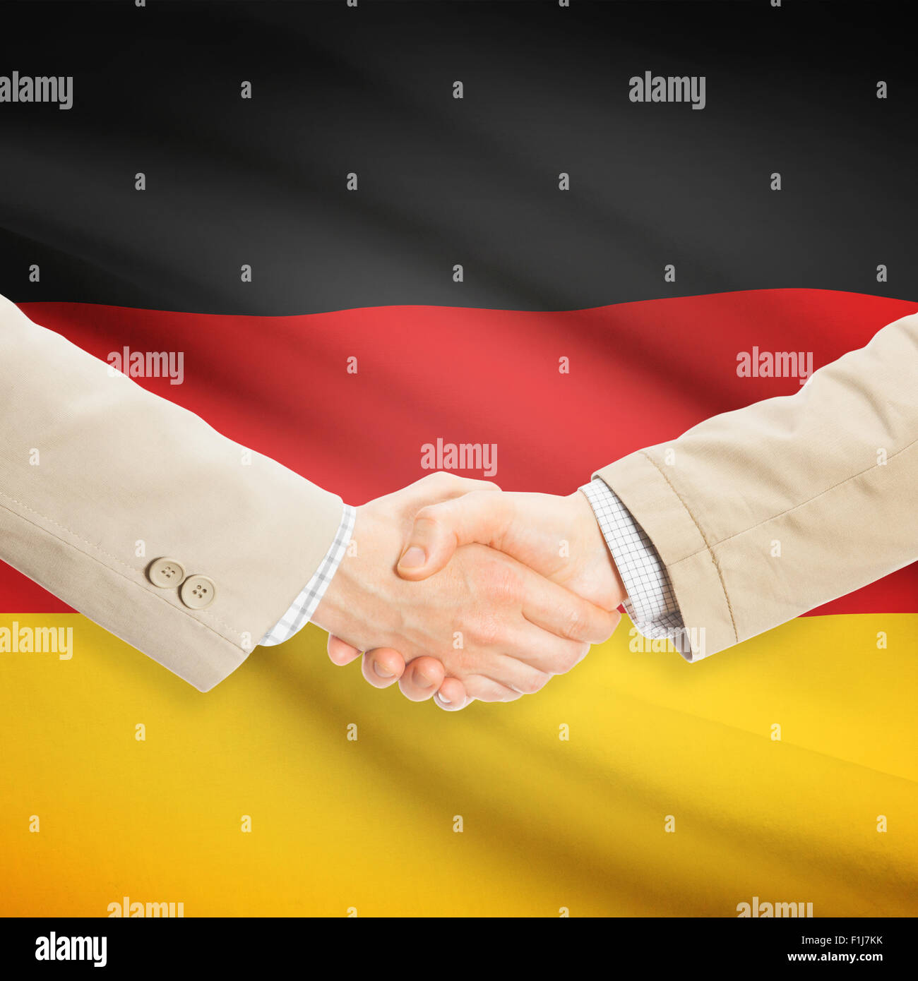 Businessmen shaking hands with flag on background - Germany Stock Photo ...