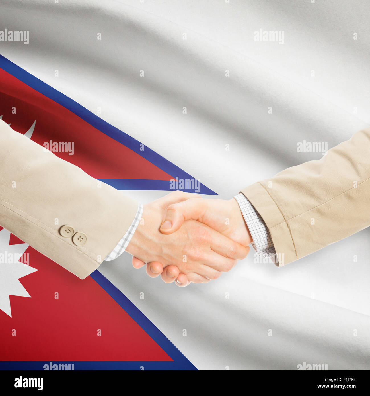 Businessmen shaking hands with flag on background - Nepal Stock Photo ...