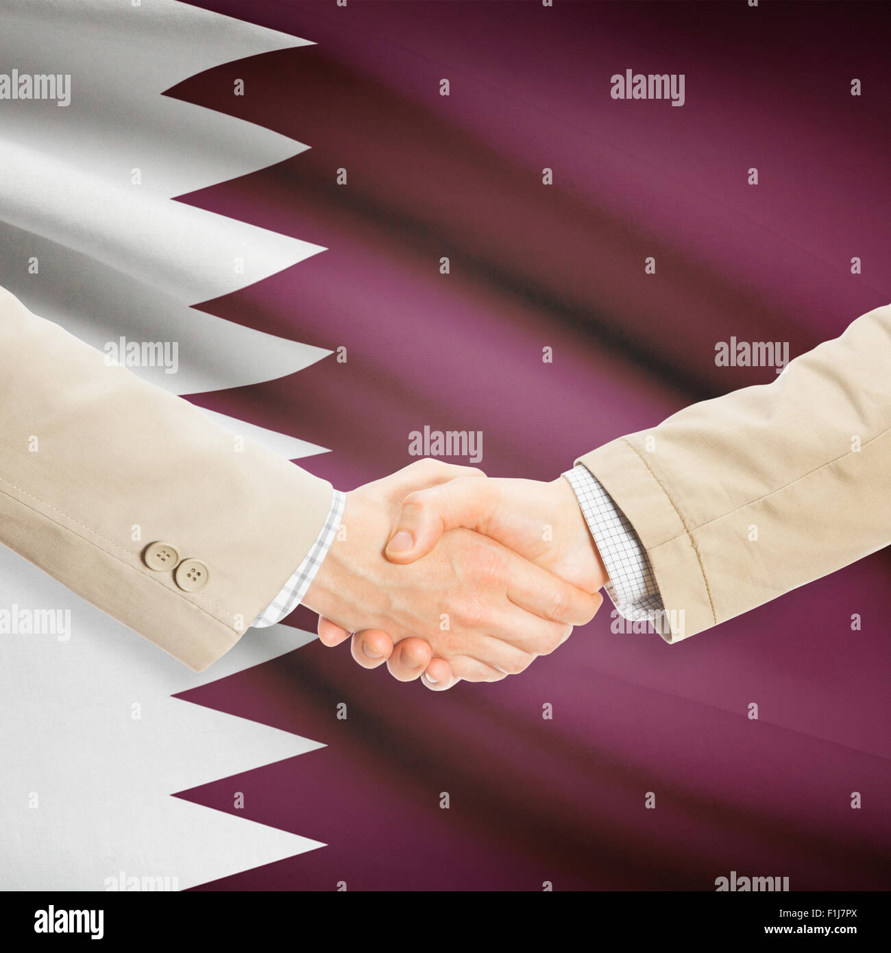 Businessmen shaking hands with flag on background - Qatar Stock Photo ...