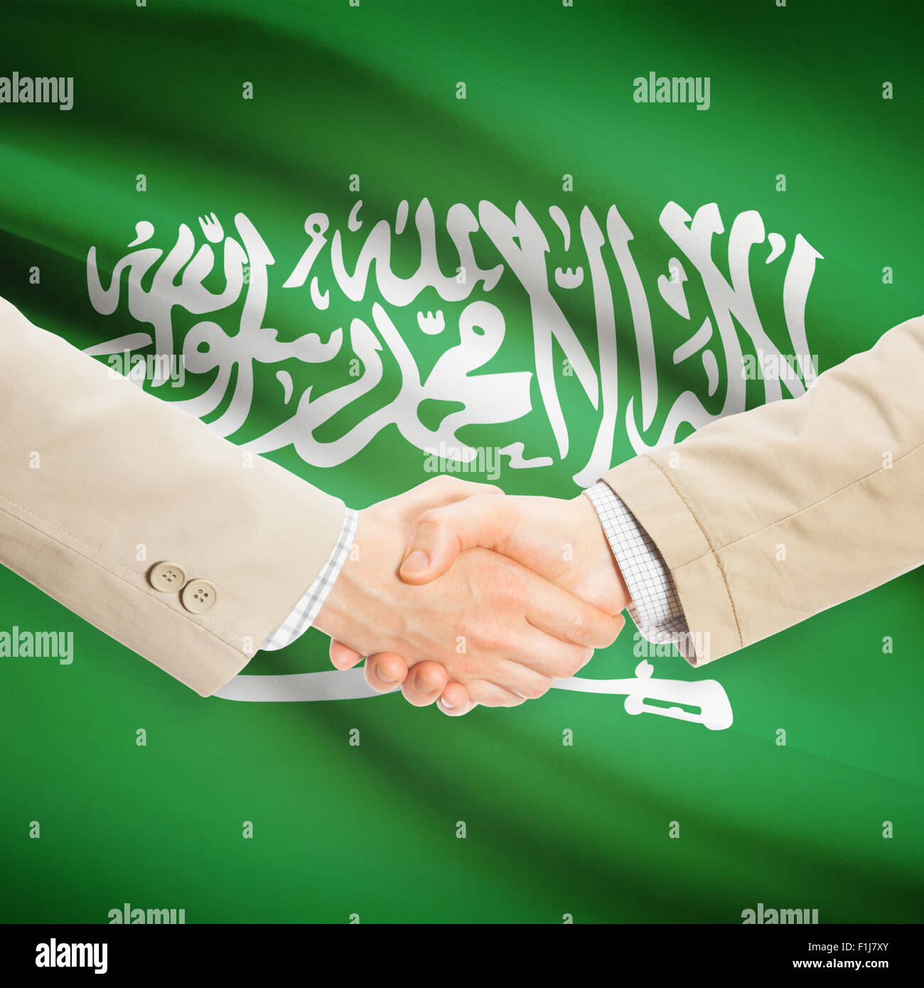 Businessmen shaking hands with flag on background - Saudi Arabia Stock ...