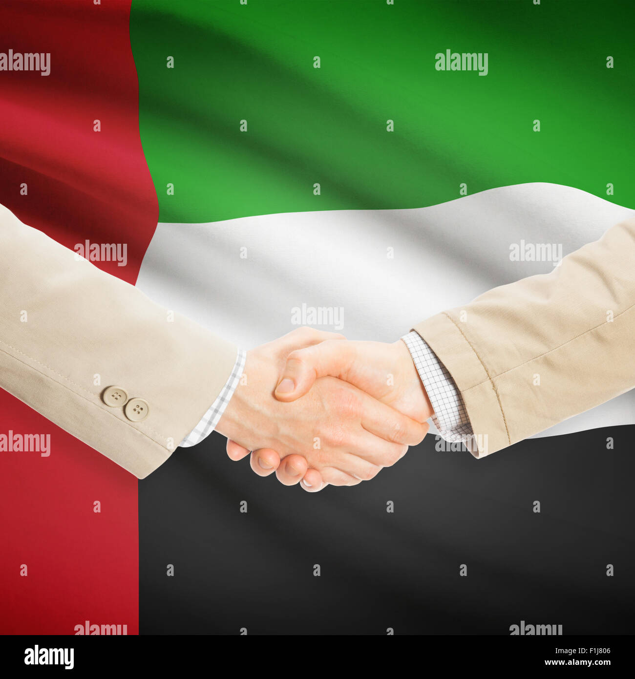 Businessmen shaking hands with flag on background - United Arab ...