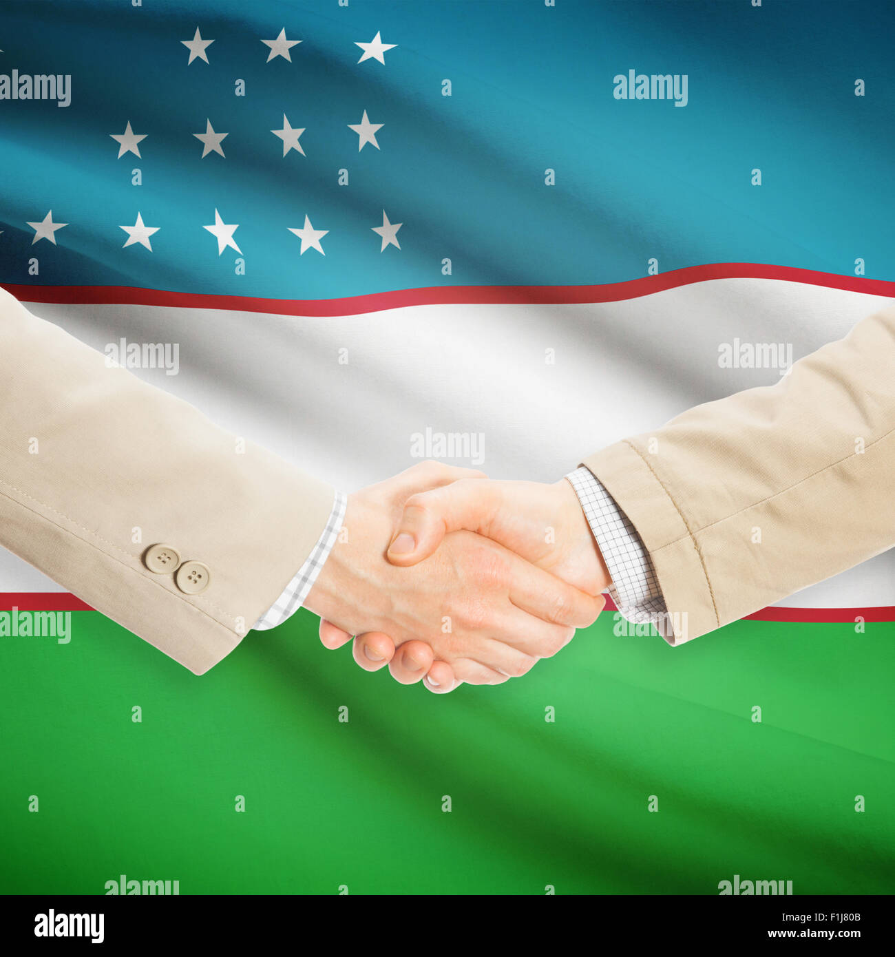 Businessmen shaking hands with flag on background - Uzbekistan Stock ...