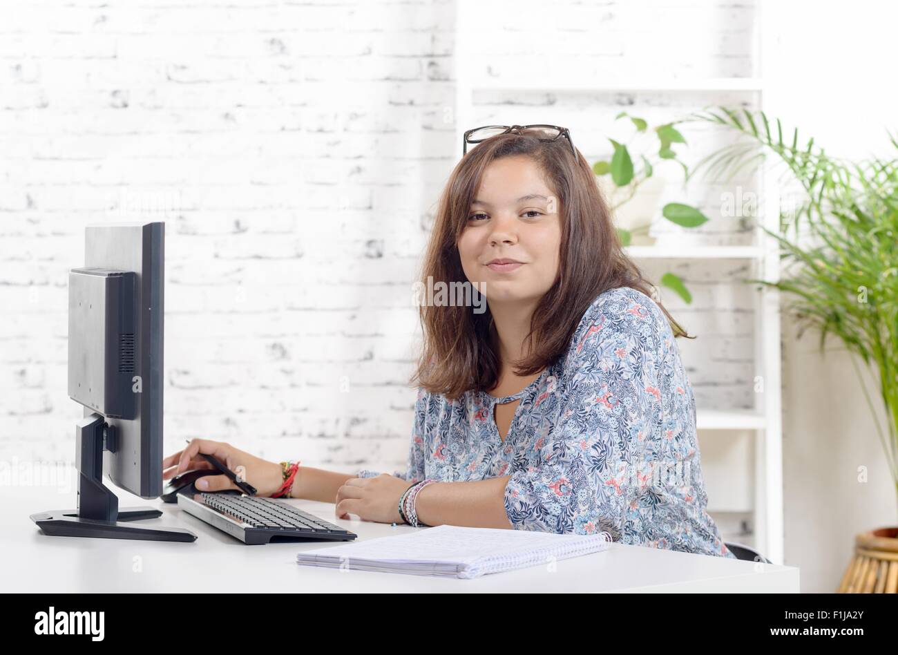 a teenage girl doing her homework with his computer Stock Photo - Alamy
