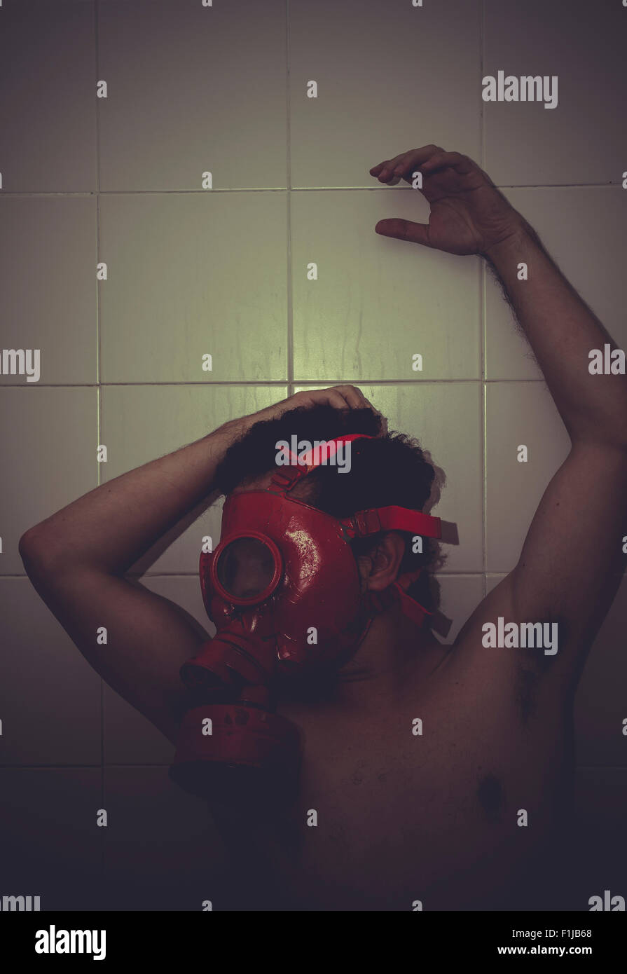 Frustration, desperate man, anguish and suffering with red gas mask ...