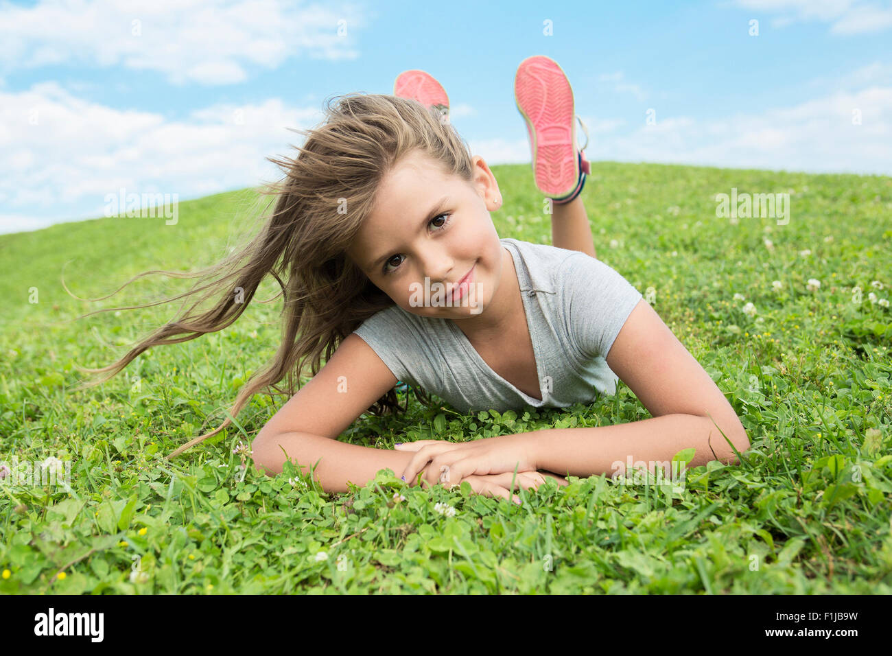 Beautiful portrait of a little girl outside on grass Stock Photo - Alamy