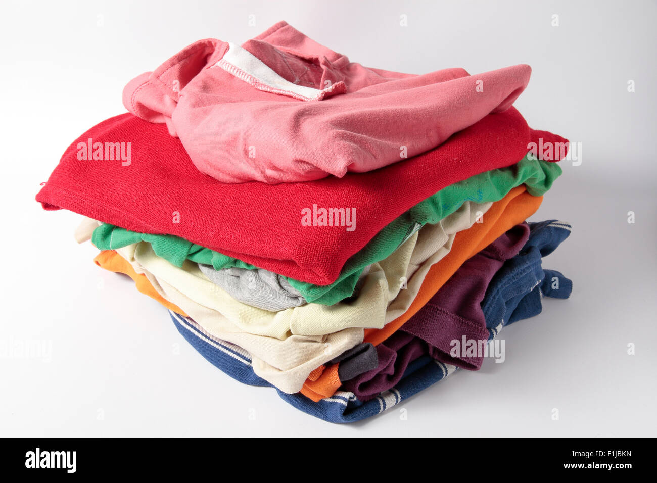 used clothes of differents colors isolated on white background Stock ...