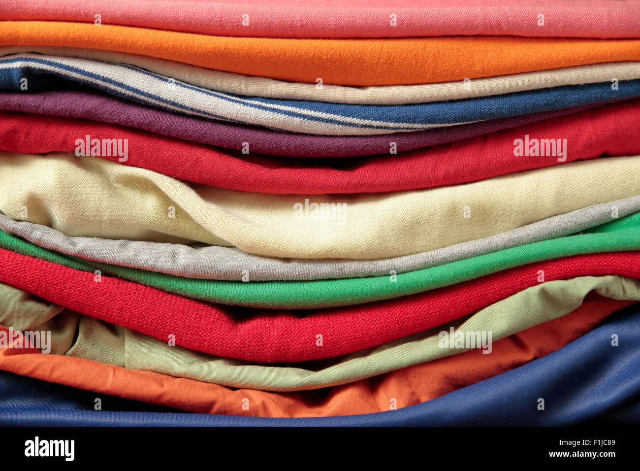 background of used clothes of differents colors Stock Photo - Alamy