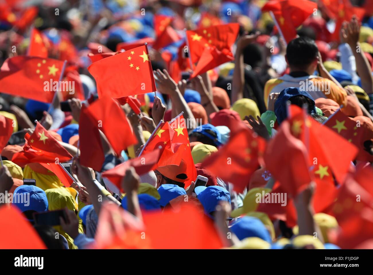 Beijing, China. 3rd Sep, 2015. Spectators holding China's national ...