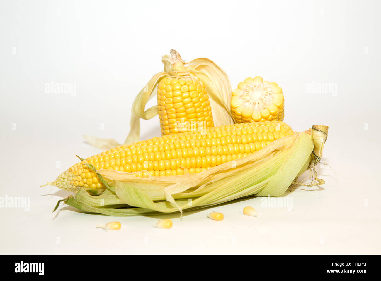 A few mature ears of corn on over white Stock Photo - Alamy