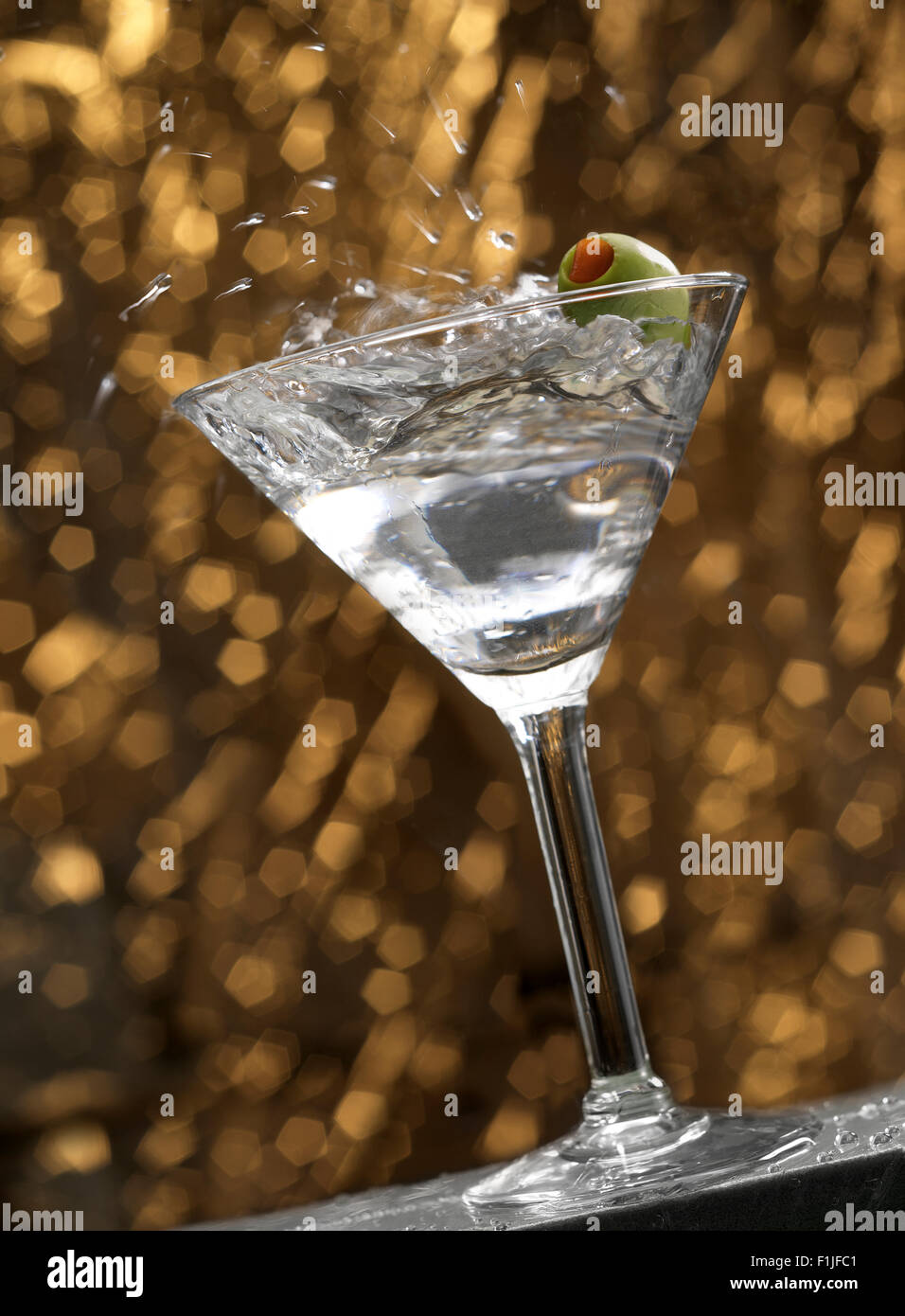 An olive dropping into a martini cocktail Stock Photo - Alamy