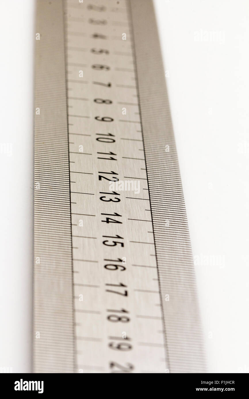 Ruler. Grey metal ruler, selective focus, viewed above and along on ...