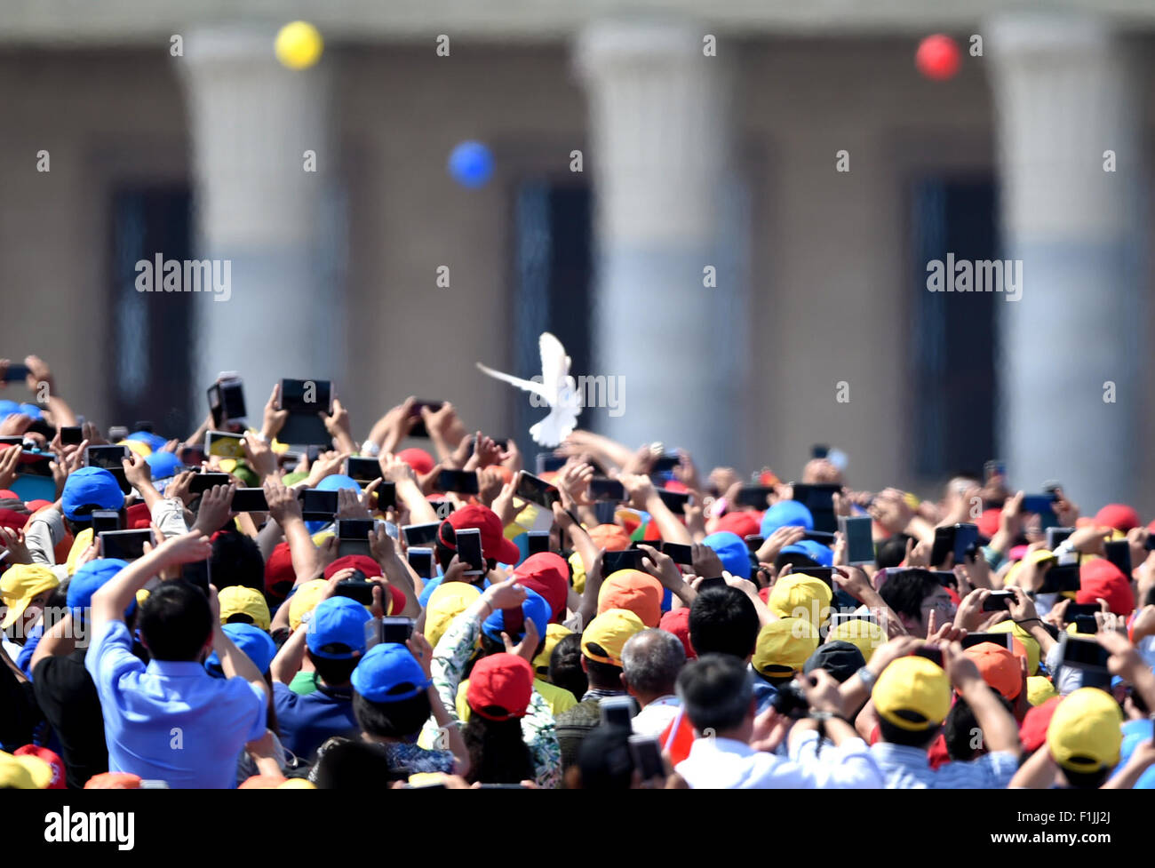 Beijing, China. 3rd September, 2015. People take photos of white doves ...