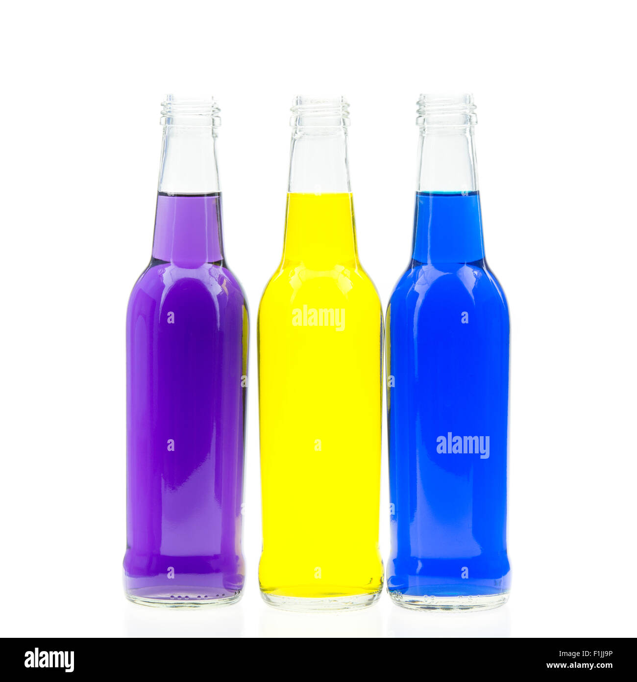 Three colorful bottles, isolated on white background Stock Photo - Alamy