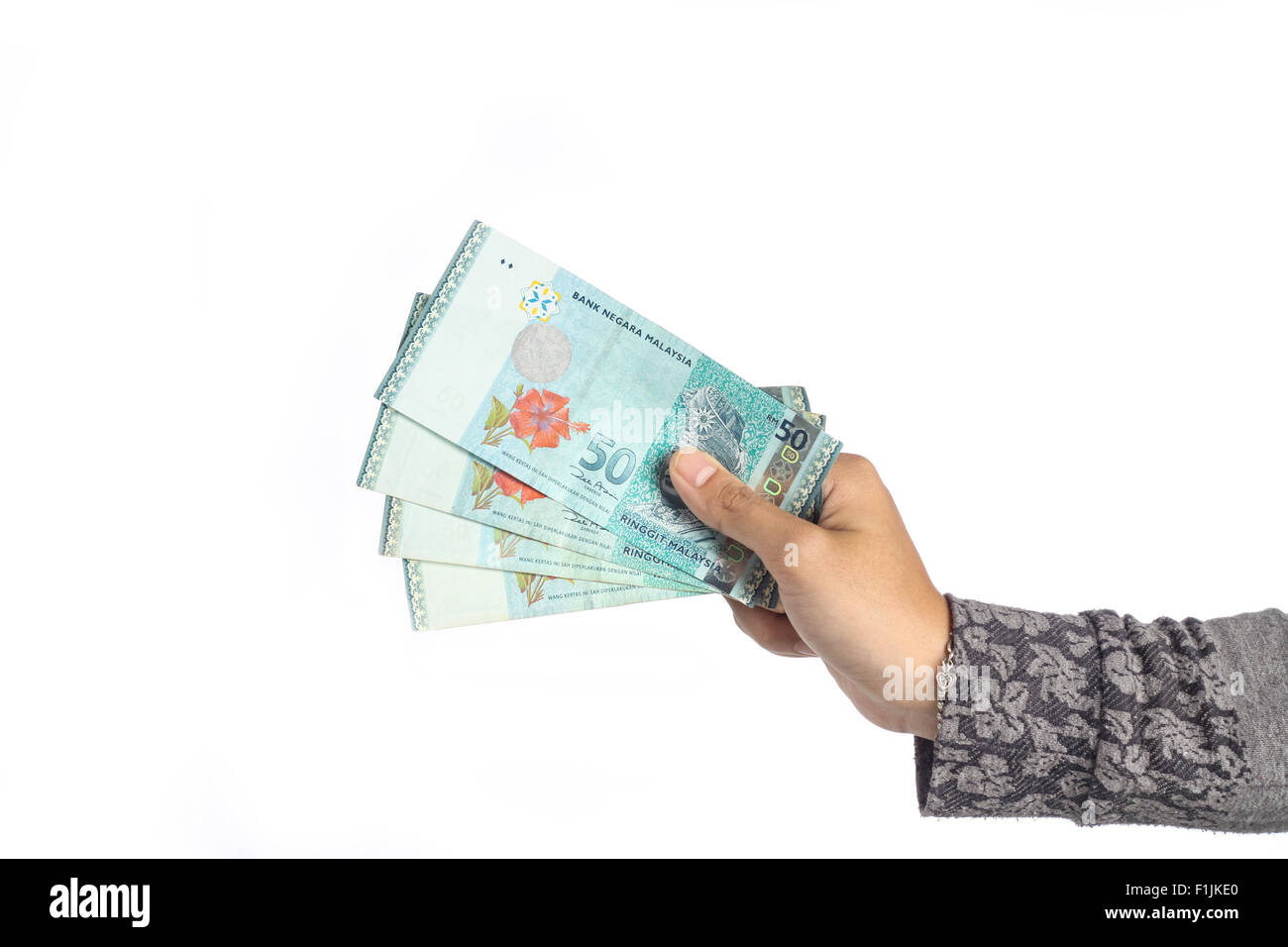 female hand holding two hundred ringgit malaysian money isolated on ...