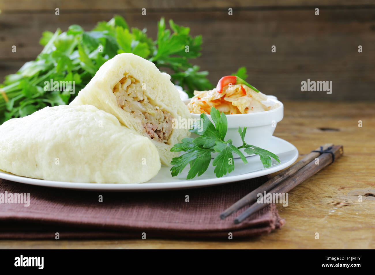 Korean steam meat pies (pigodi) served with soy sauce and kimchi Stock ...