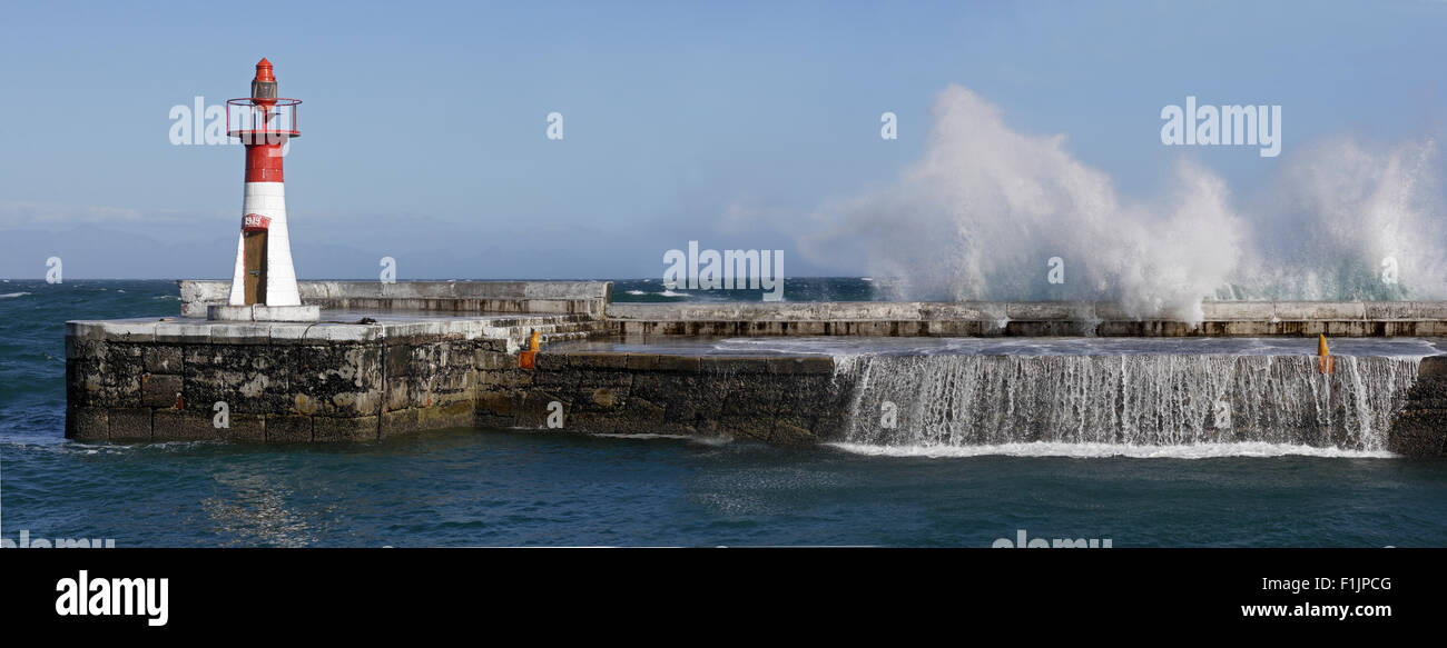 Wave crashing over pier Stock Photo - Alamy