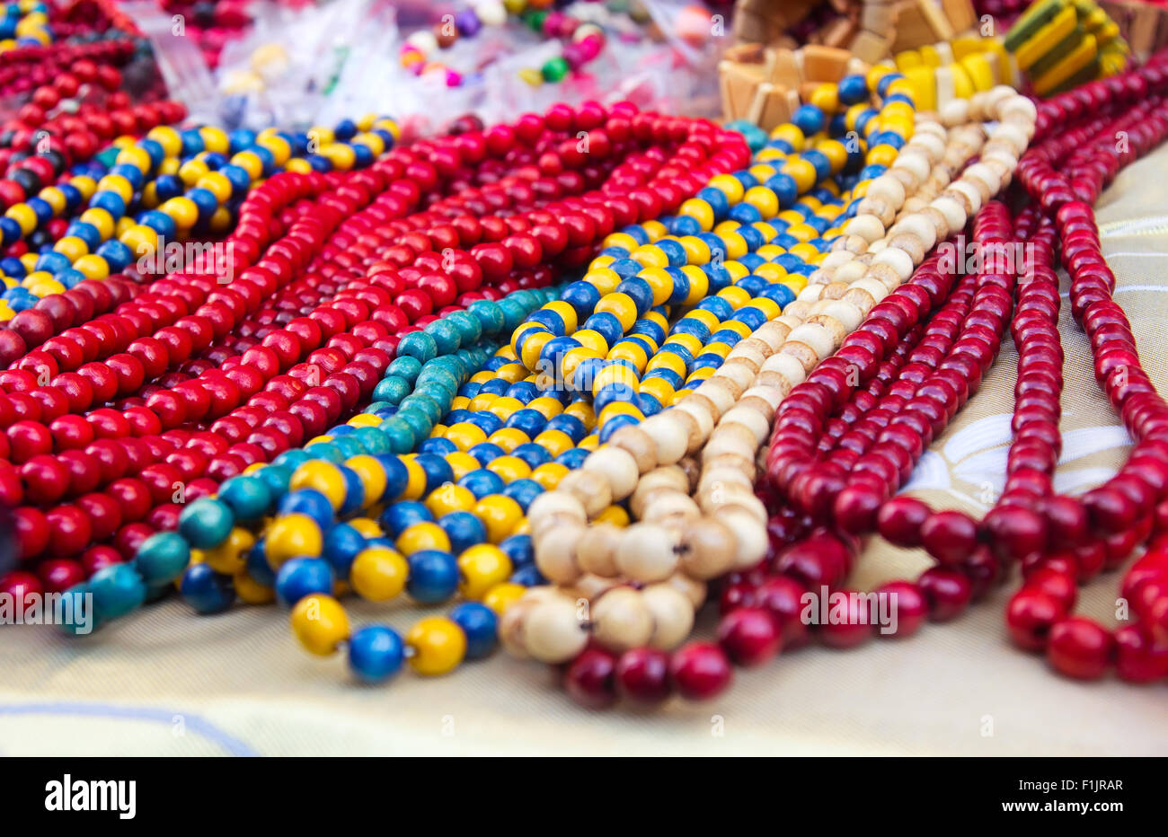 Ethnic wooden multicolored necklaces at market, traditional decorations ...
