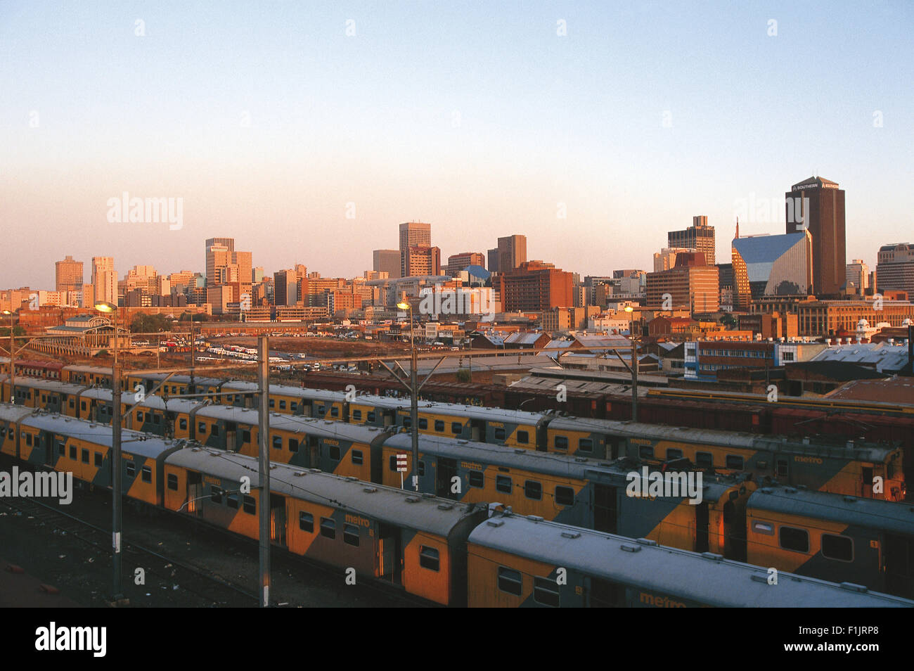 Johannesburg skyline with trains and railway station in foreground ...