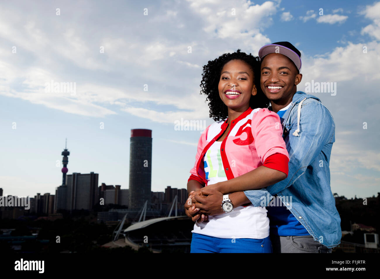 Young black couple stand in front of cityscape Stock Photo - Alamy