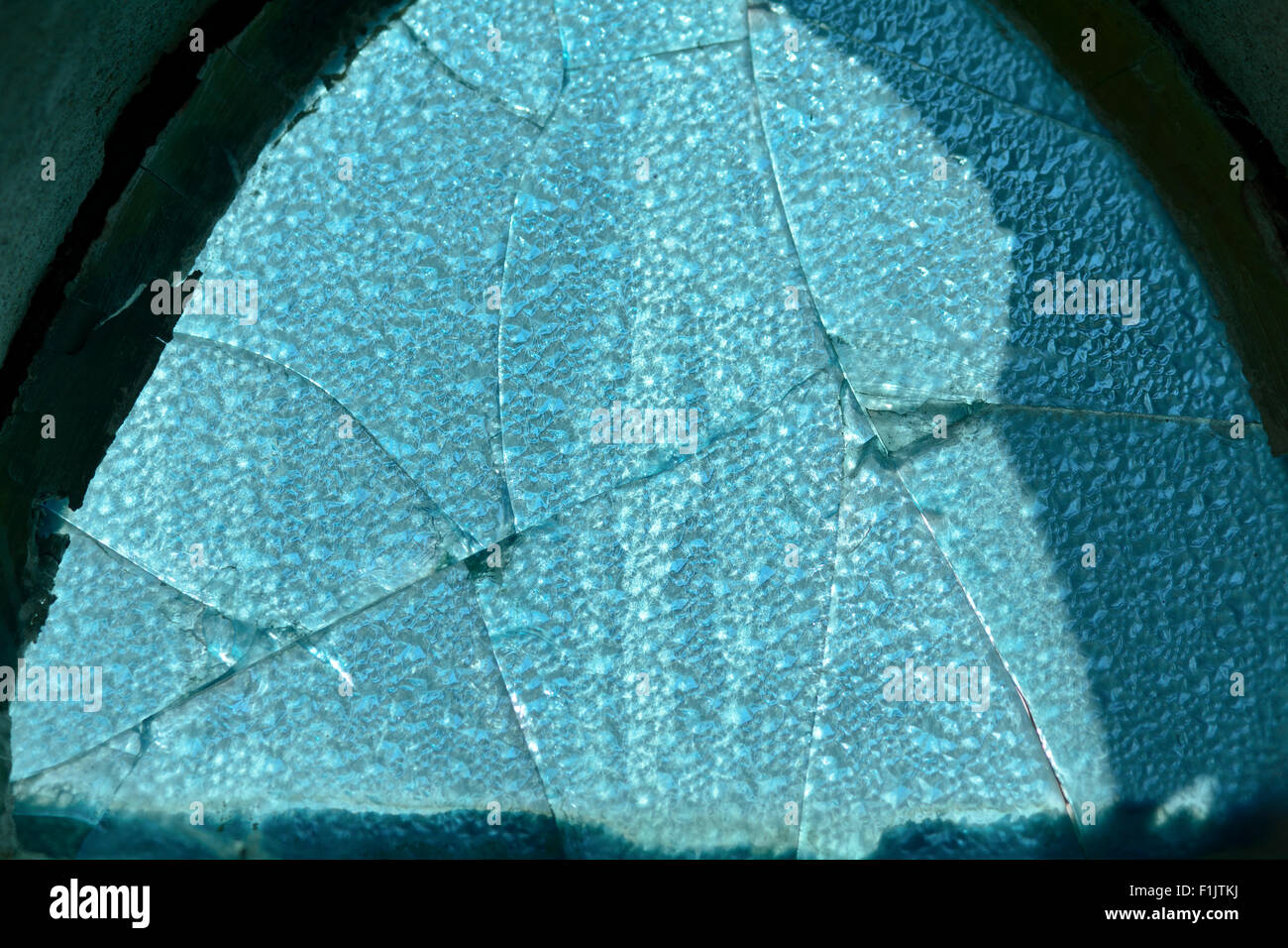 Broken blue stained glass windows in tomb in cemetery in Bordeaux ...