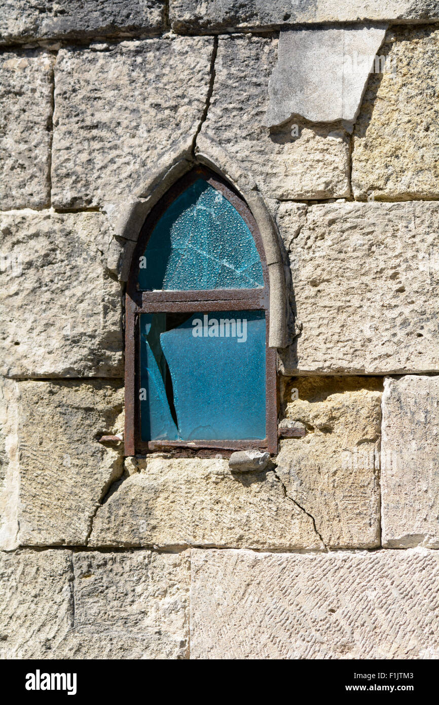 Broken blue stained glass windows in tomb in cemetery in Bordeaux ...