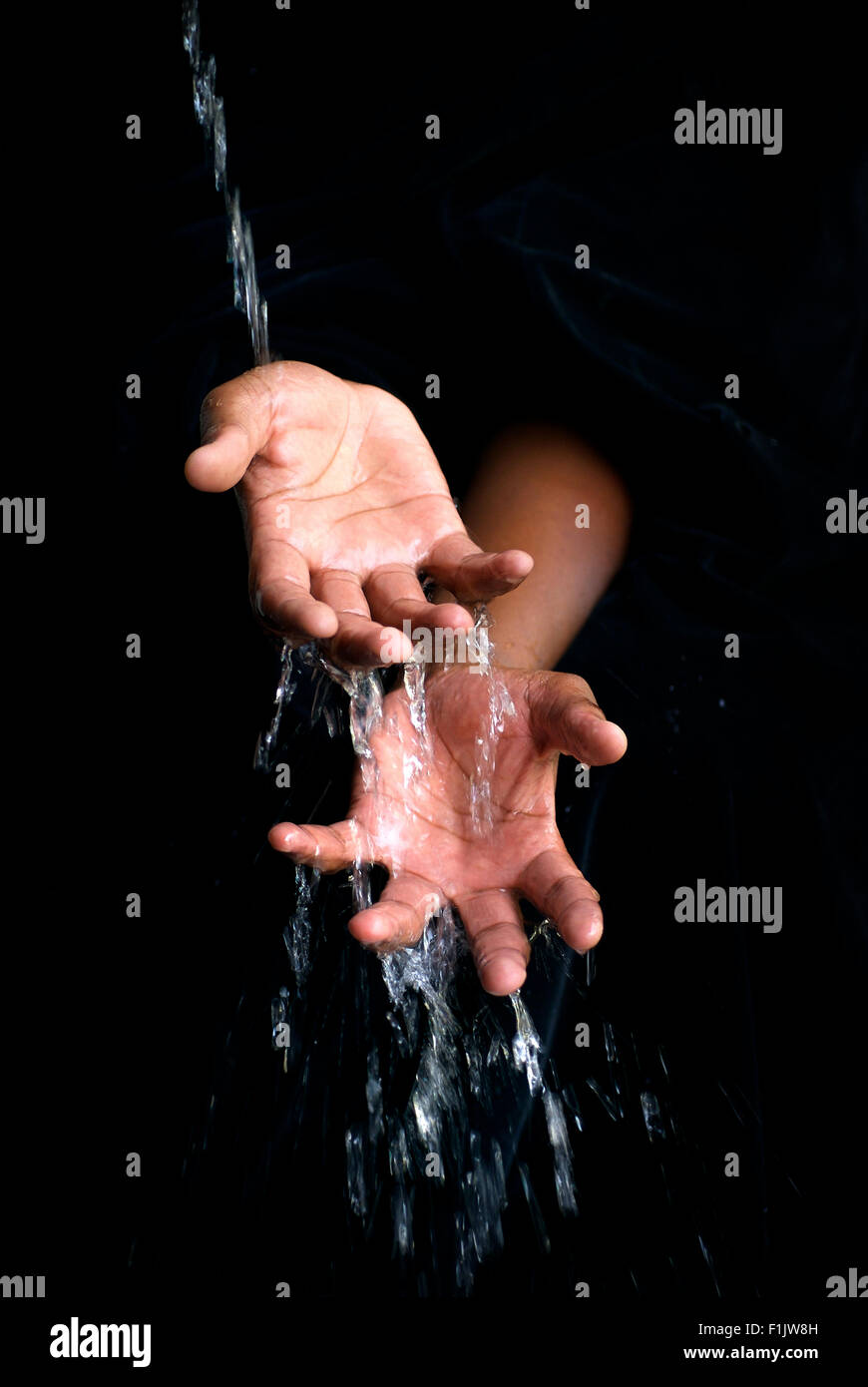 Water running over Black hands Stock Photo - Alamy