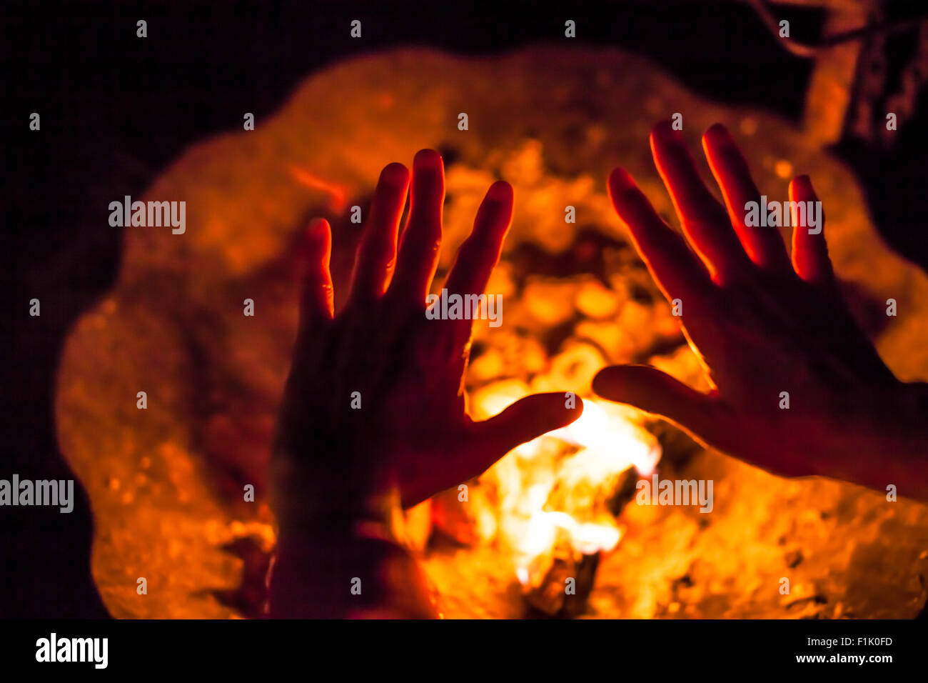 Warming fire hands hi-res stock photography and images - Alamy