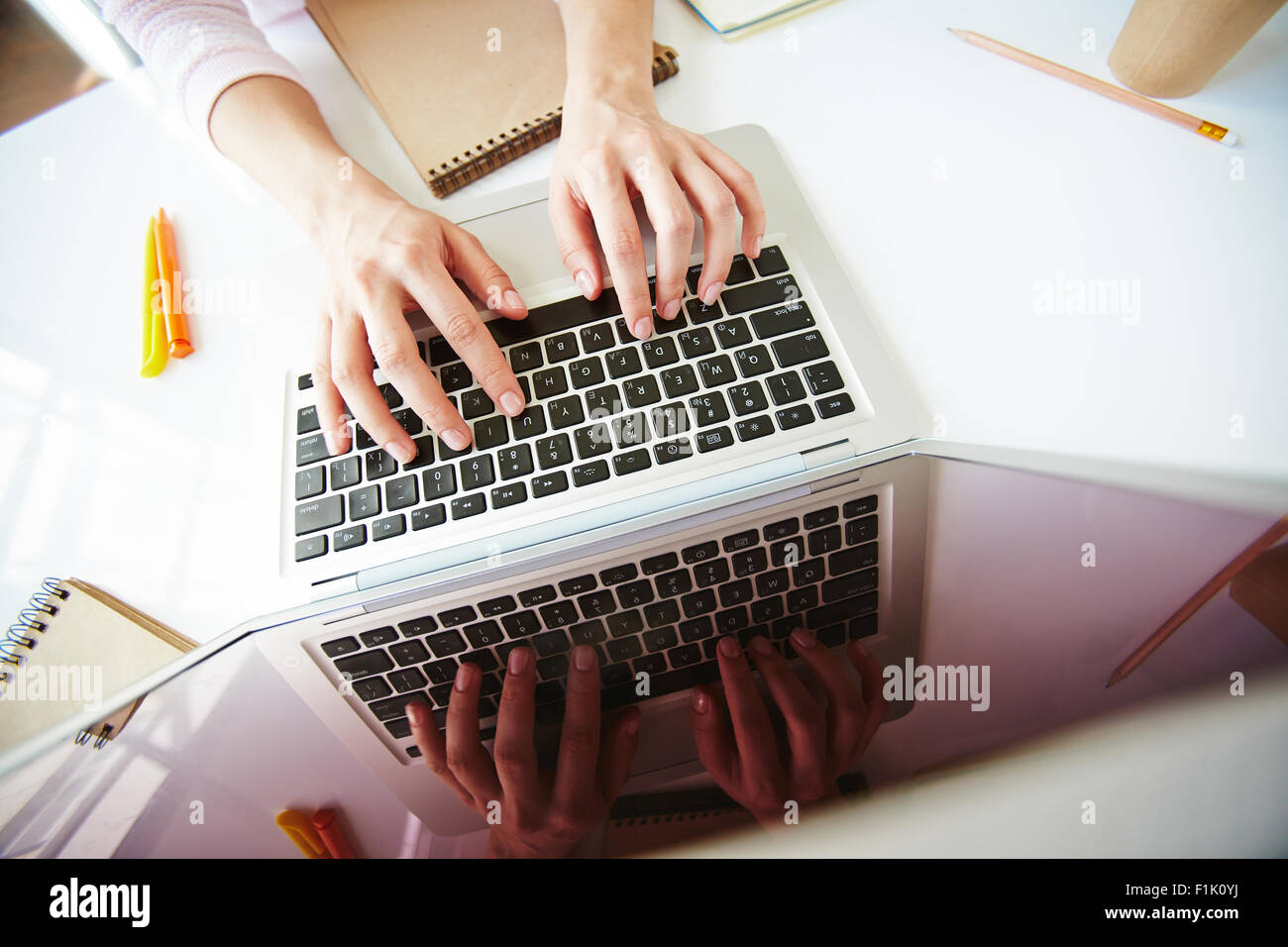 Female student pressing keys of laptop Stock Photo - Alamy