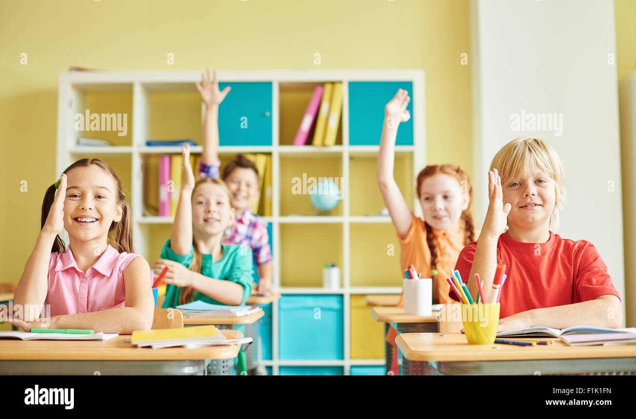 Cute schoolchildren working at lesson Stock Photo - Alamy