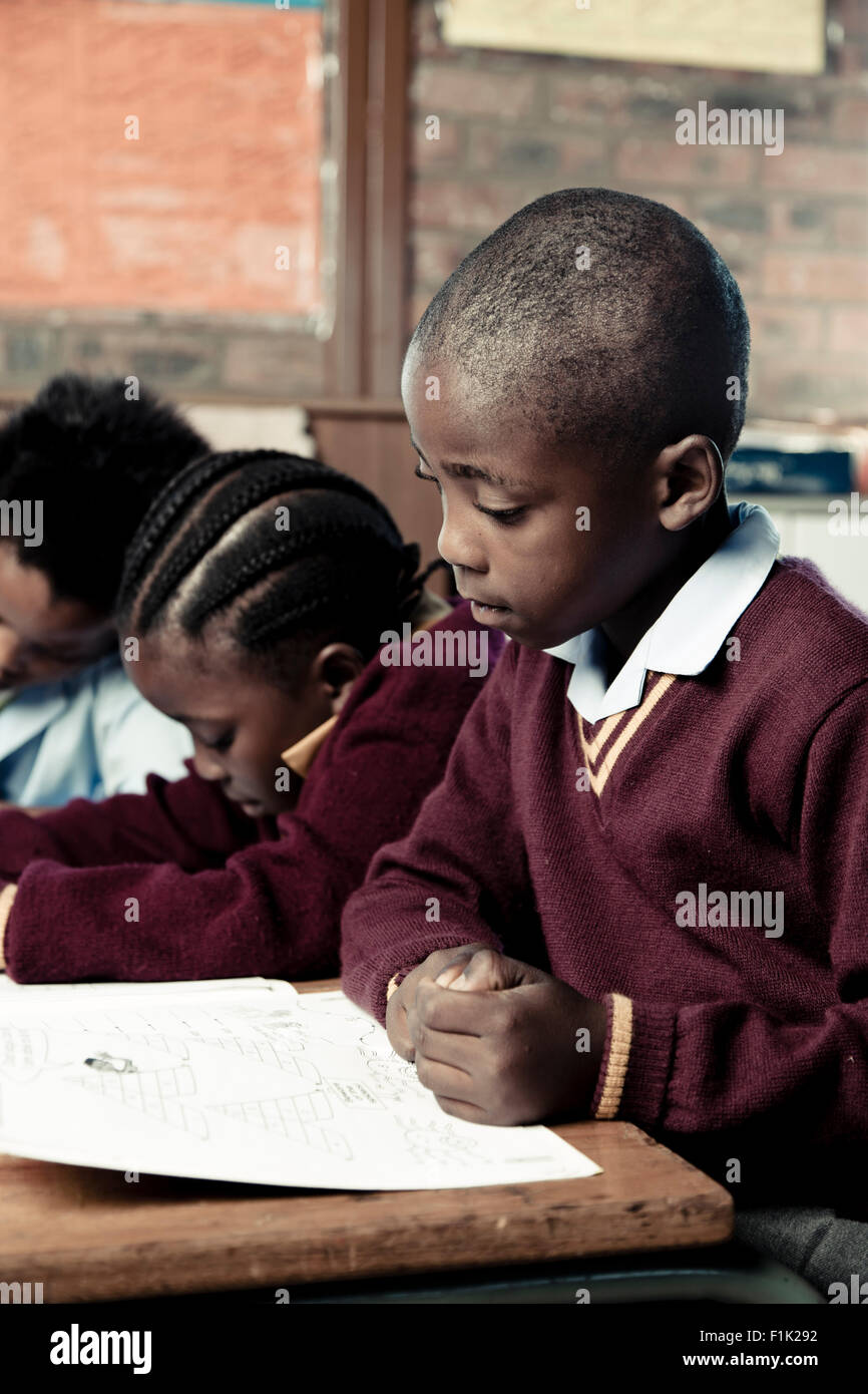 African school pupil working hard at his desk Stock Photo - Alamy