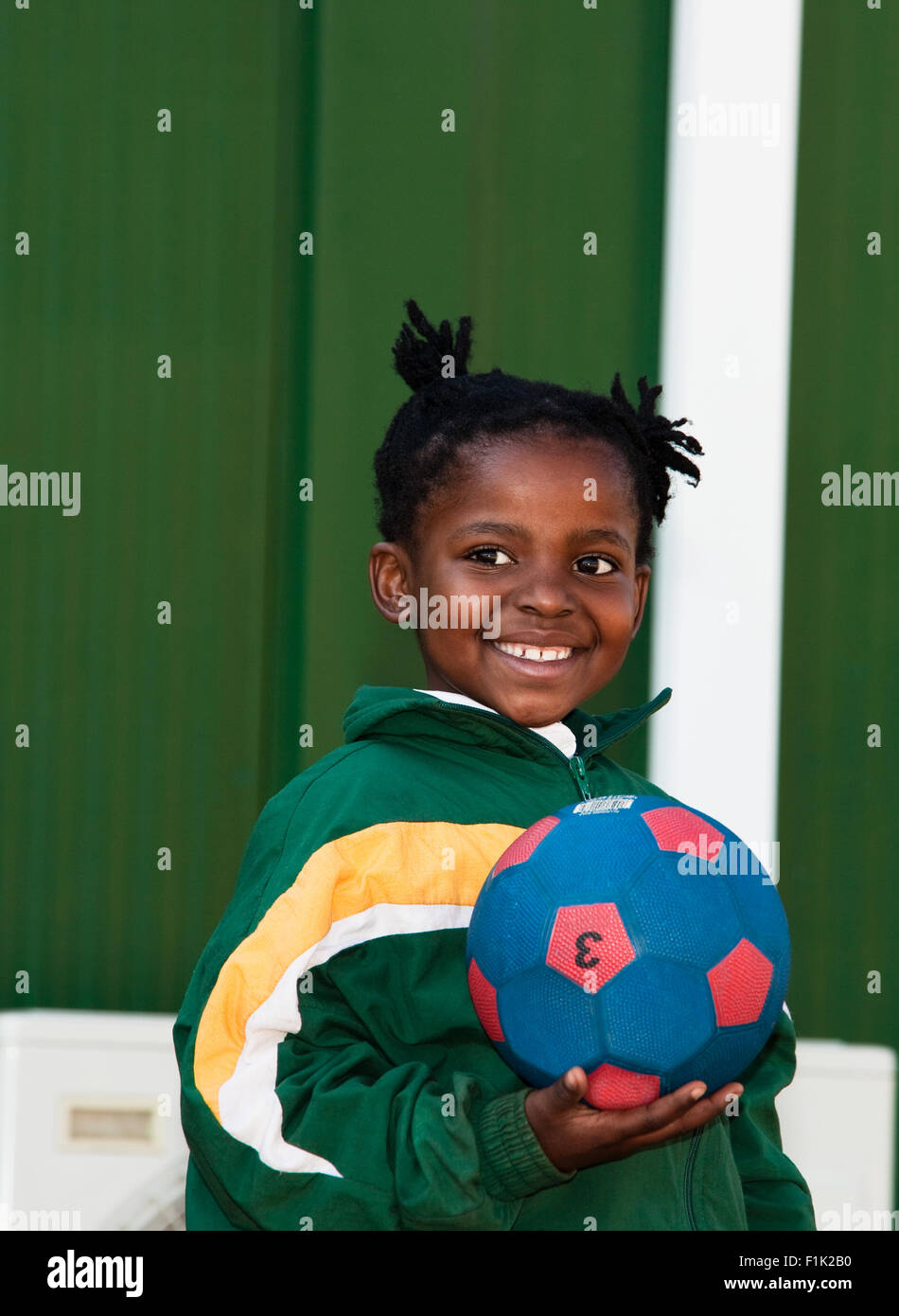 A young girl holding a soccer ball, Meyerton Primary School, Meyerton ...
